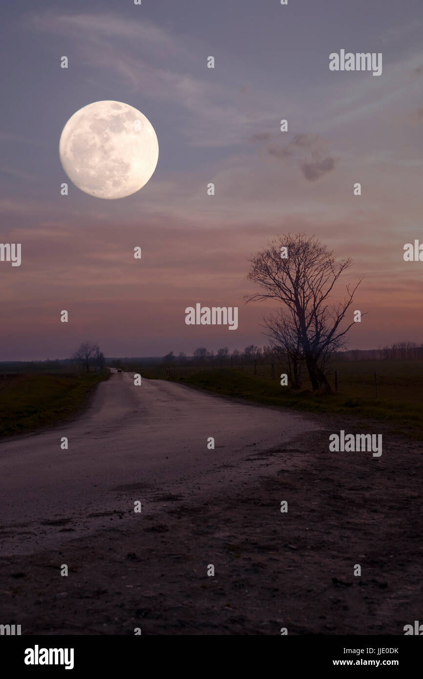 Moon and road at night Stock Photo - Alamy