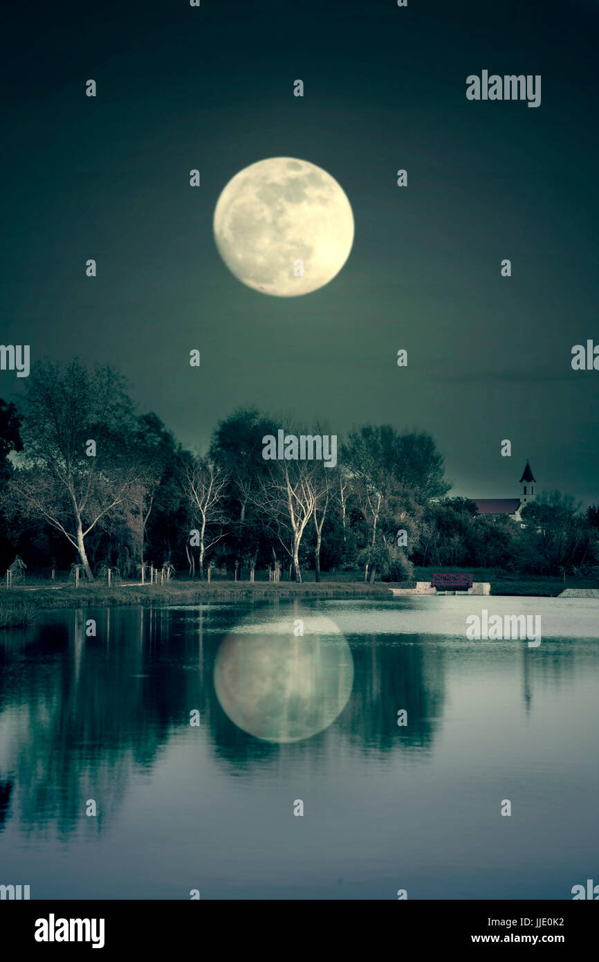 Moonrise over lake Stock Photo - Alamy
