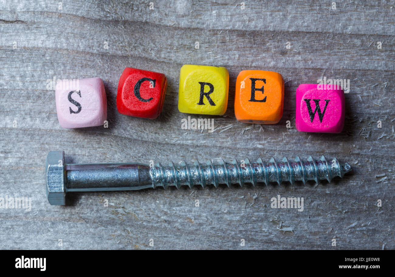 Letter cube and screw on gray wood visualization Stock Photo - Alamy