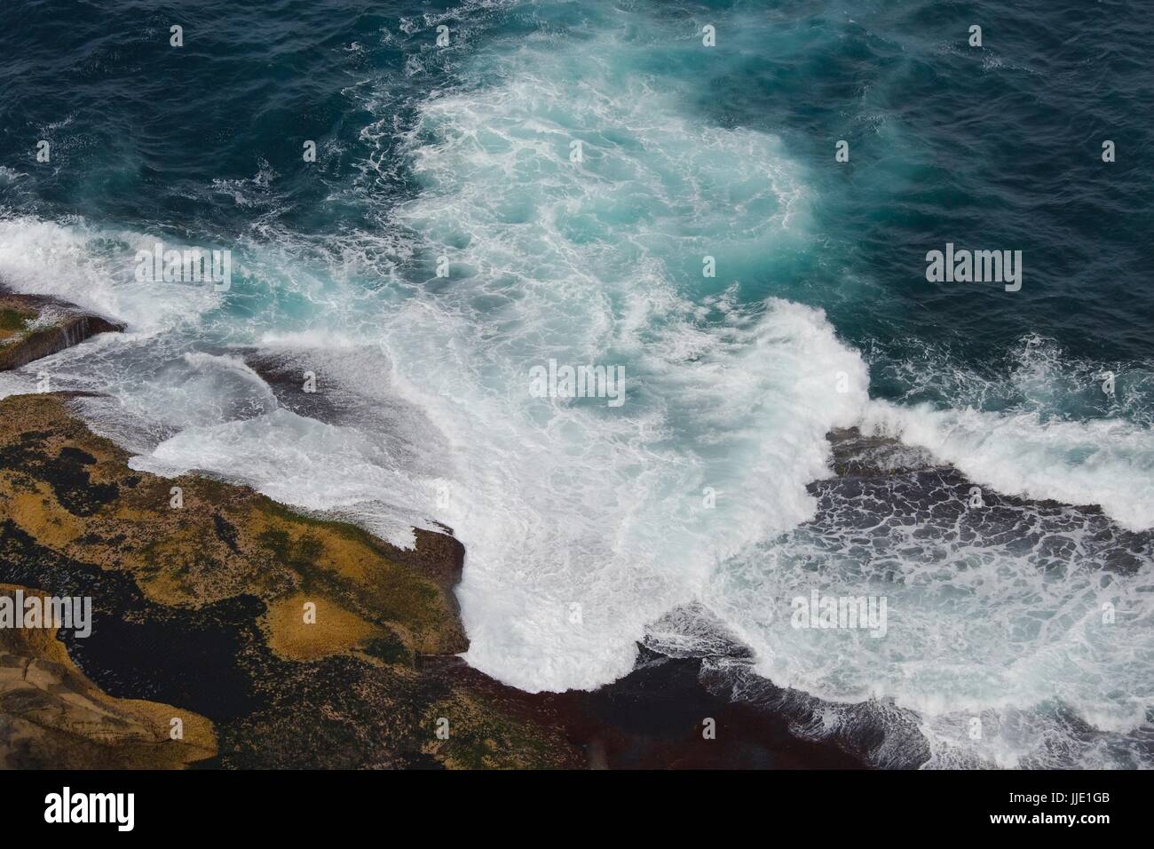 Waves hitting the sea shore cliffs Stock Photo - Alamy