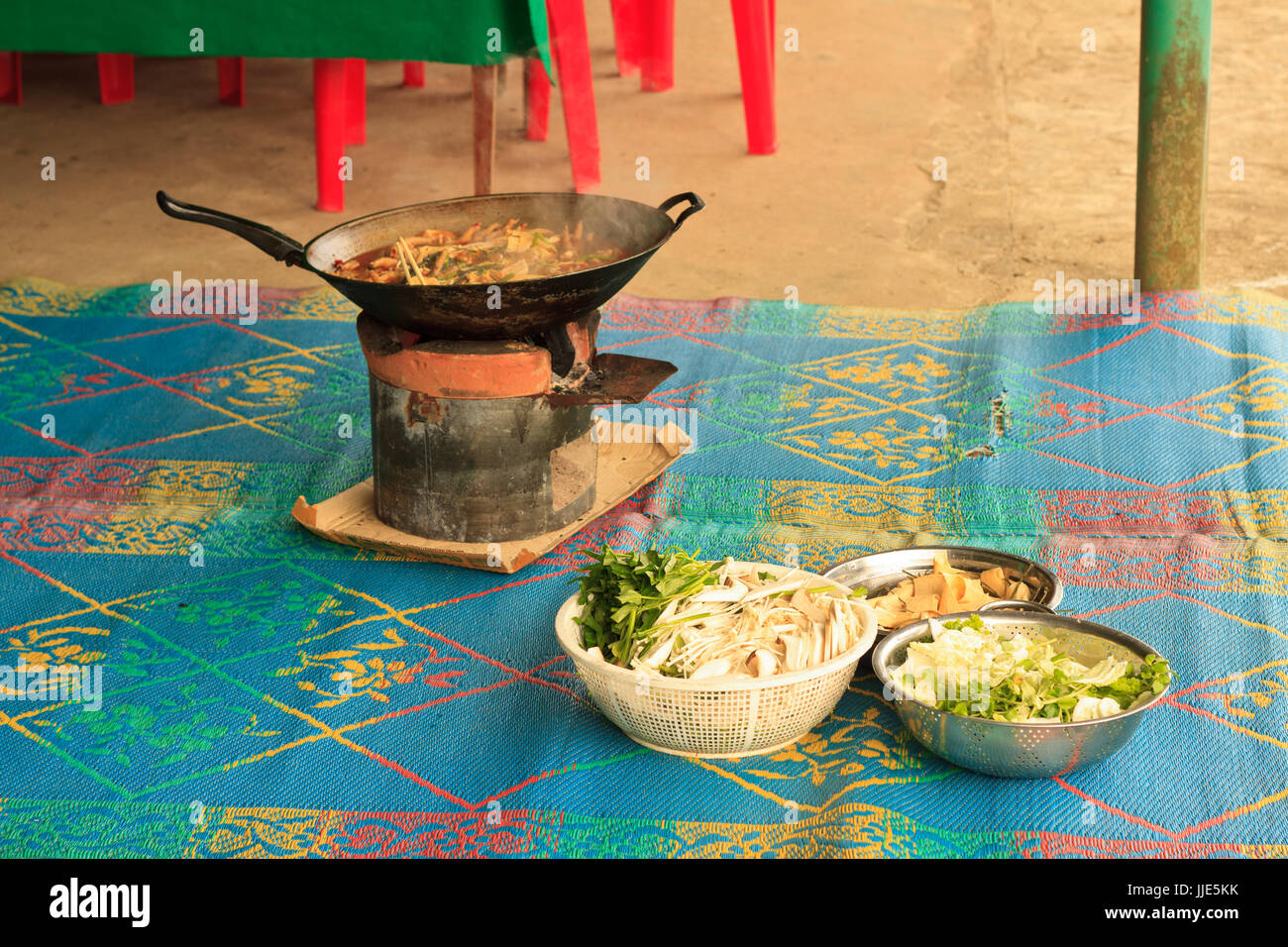 Lao food with chicken feet prepared in a big pan Stock Photo - Alamy