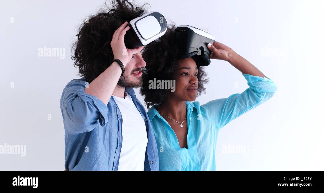 Happy multiethnic couple getting experience using VR headset glasses of ...