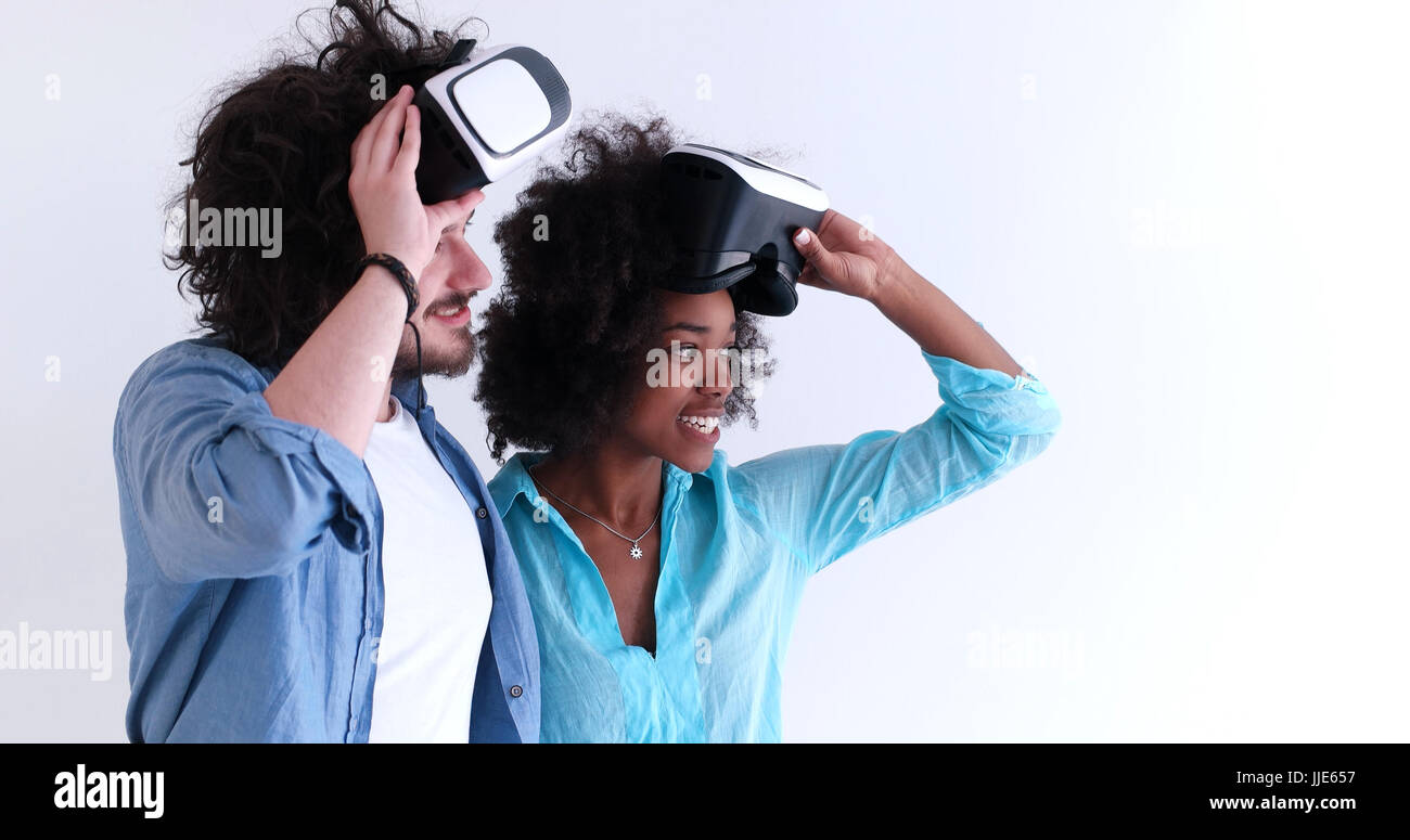 Happy multiethnic couple getting experience using VR headset glasses of ...