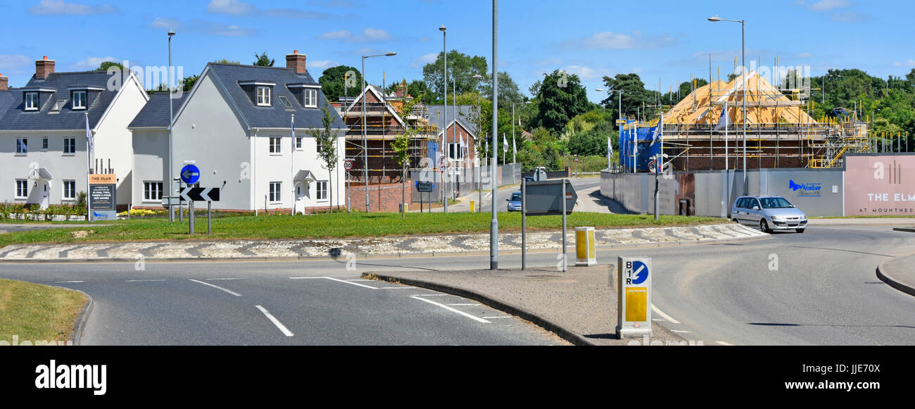 House building construction site completed new home on left with same ...