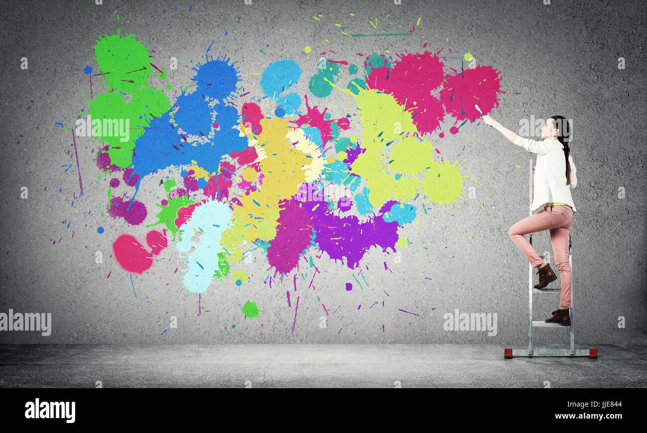 Girl paint wall in colors Stock Photo - Alamy