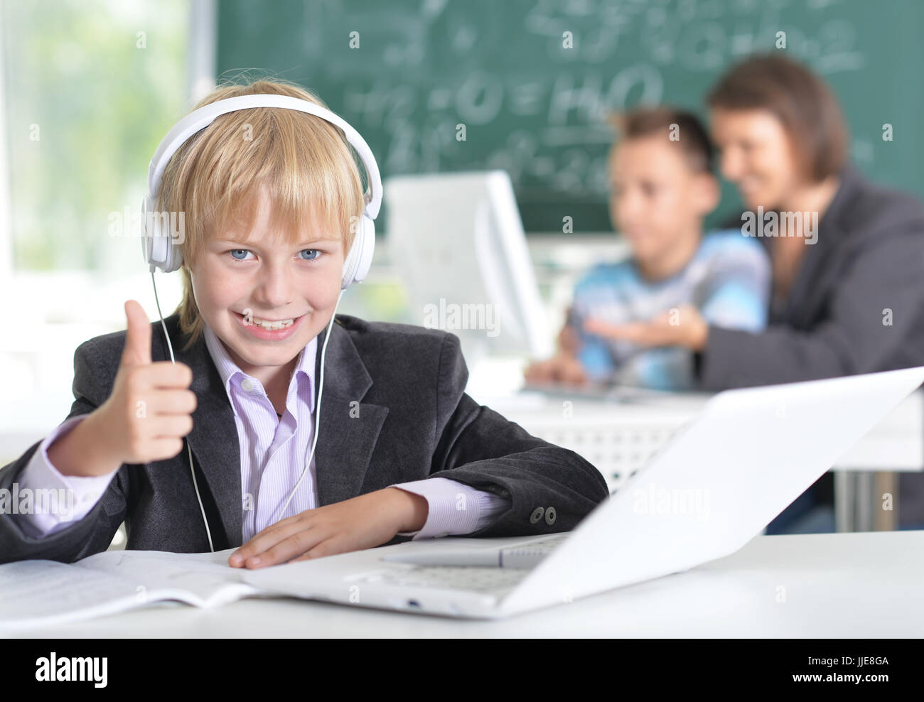 Boy in school uniform with laptop Stock Photo - Alamy
