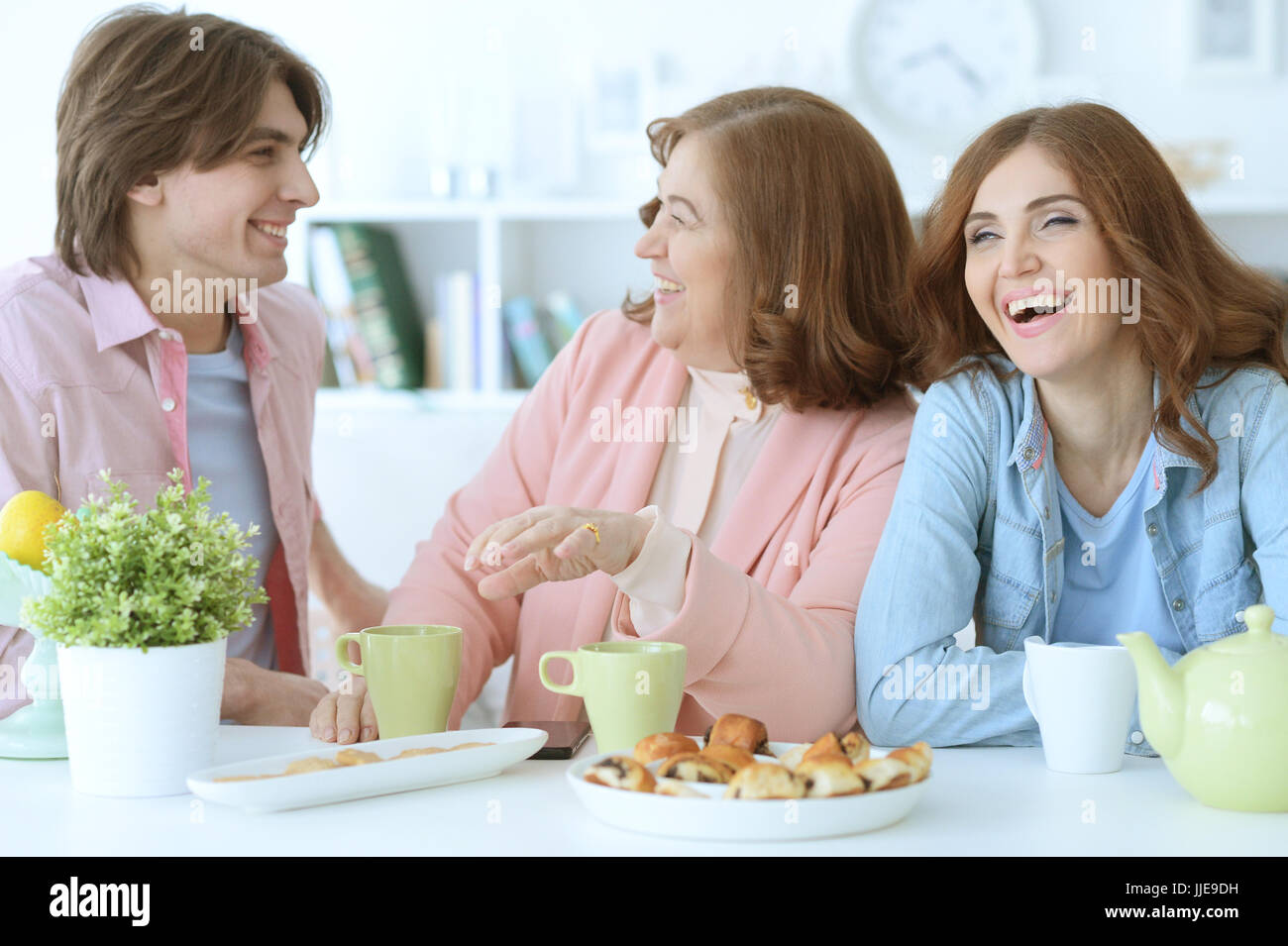 Happy family drinking tea together Stock Photo - Alamy