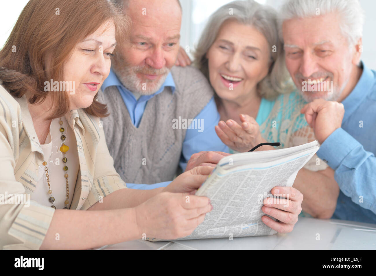 senior couples reading newspaper Stock Photo - Alamy