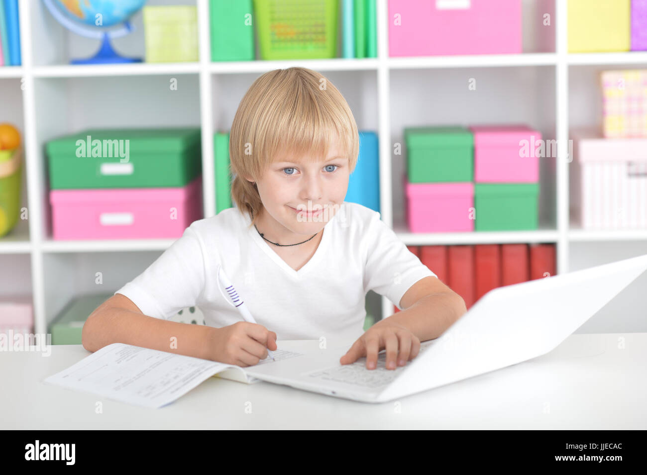 Cute little boy doing homework Stock Photo - Alamy