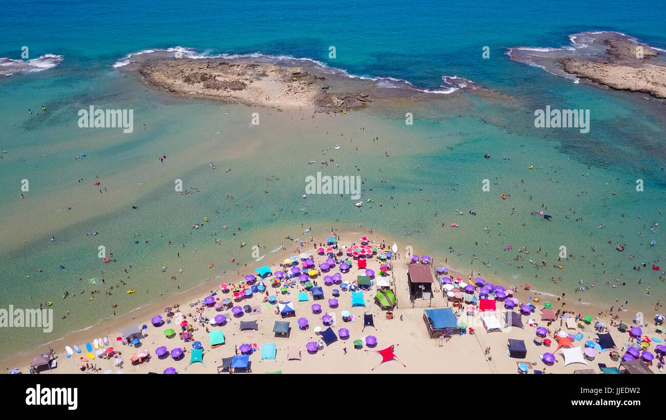 Tropical beach with colorful umbrellas - Top down aerial view Stock ...