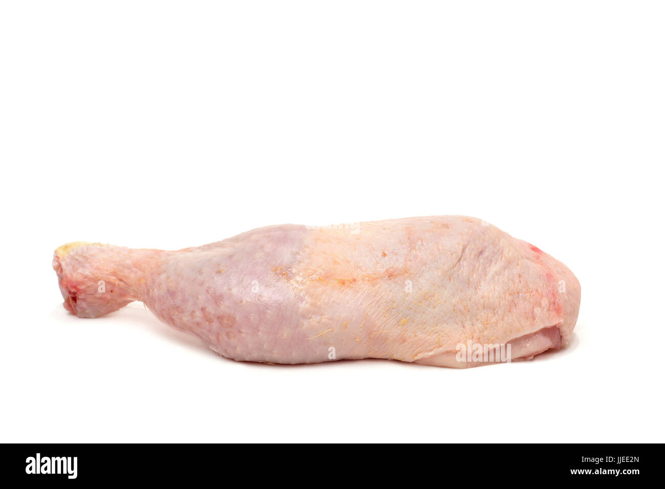 closeup of a raw chicken leg on a white background Stock Photo - Alamy