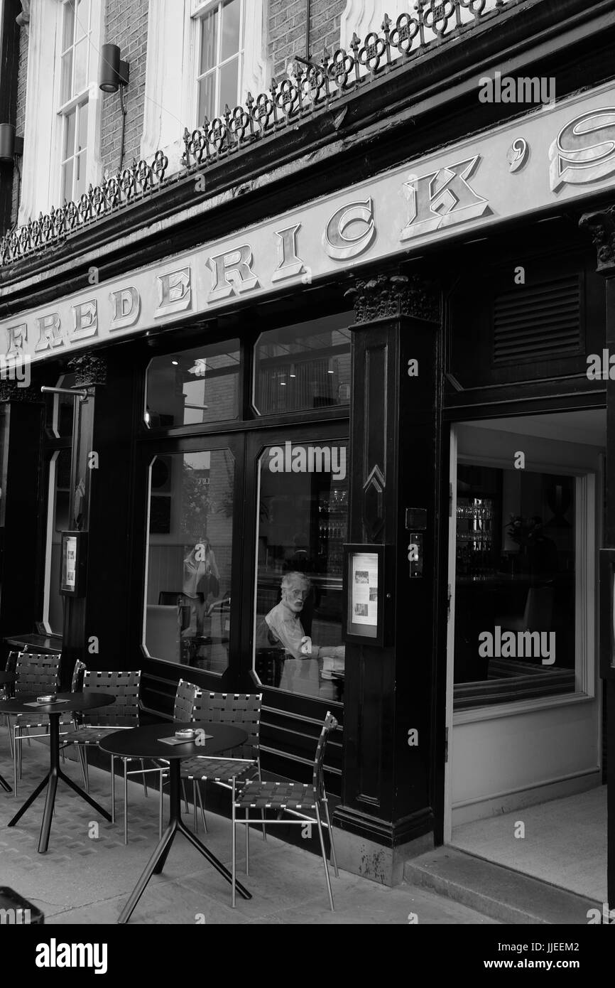 Man sitting alone looking sadly out of the window of Frederick's bar ...