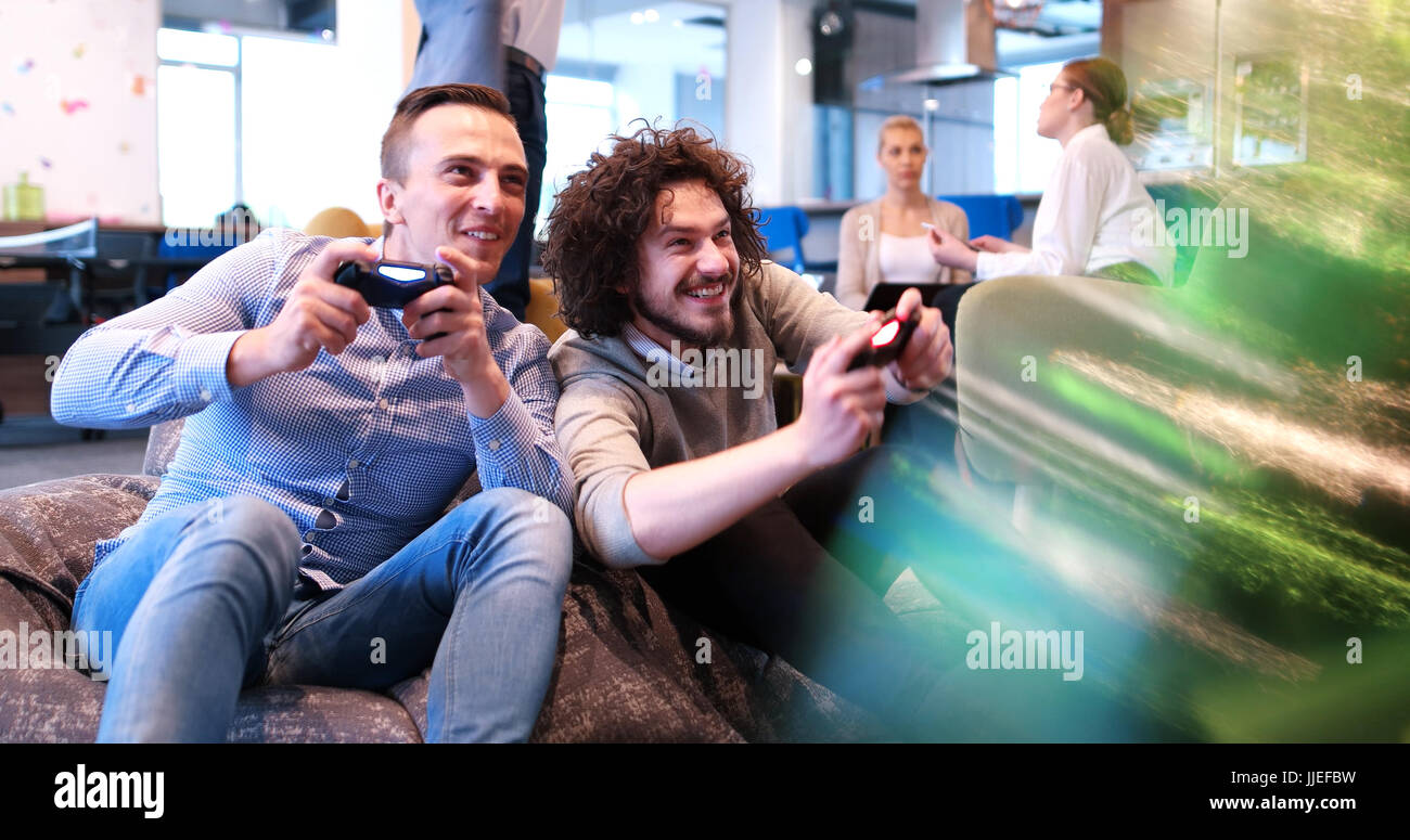 Work hard play hard. Office Workers Playing computer games Stock Photo ...