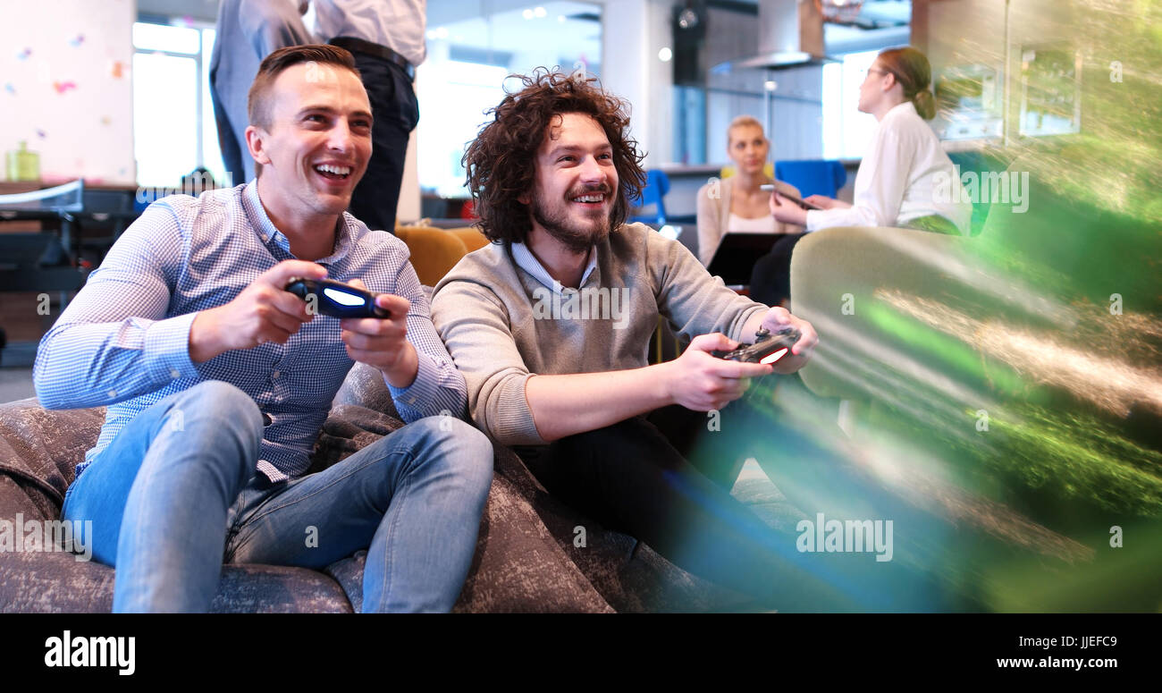 Work hard play hard. Office Workers Playing computer games Stock Photo ...