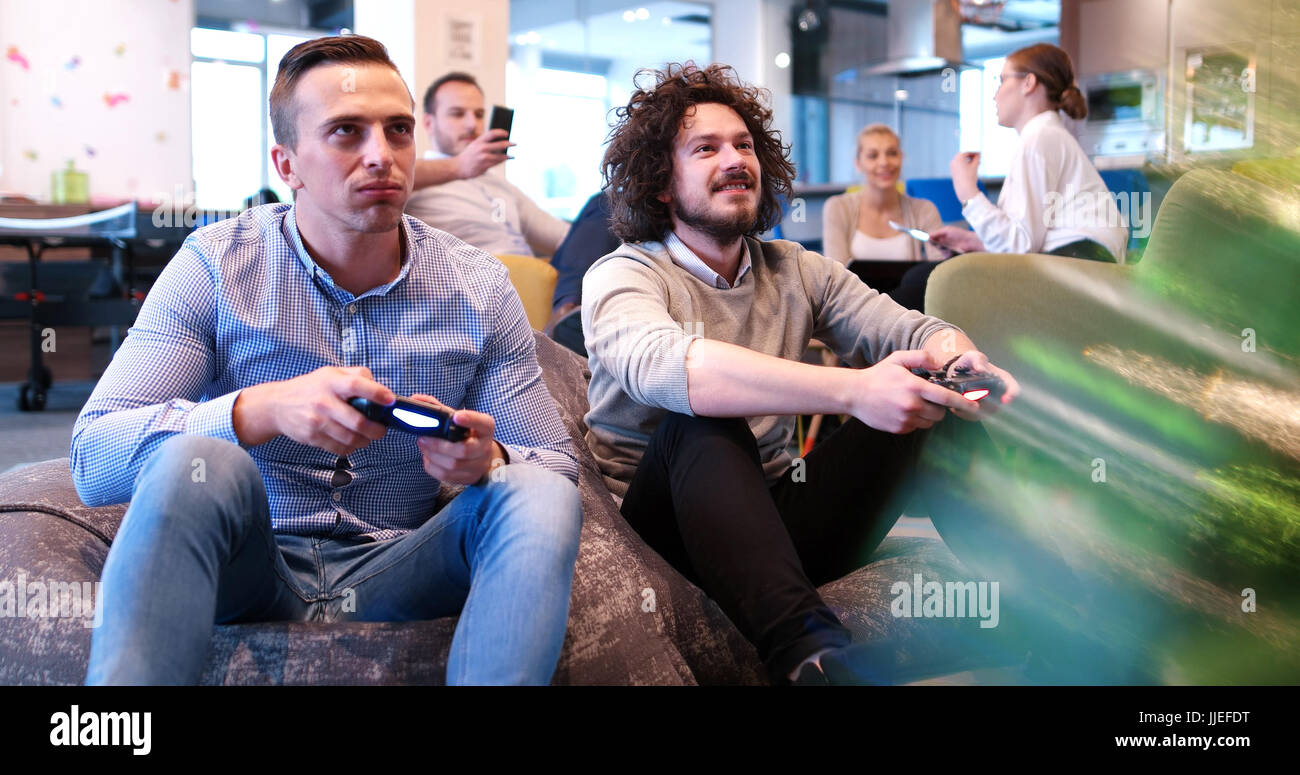 Work hard play hard. Office Workers Playing computer games Stock Photo ...