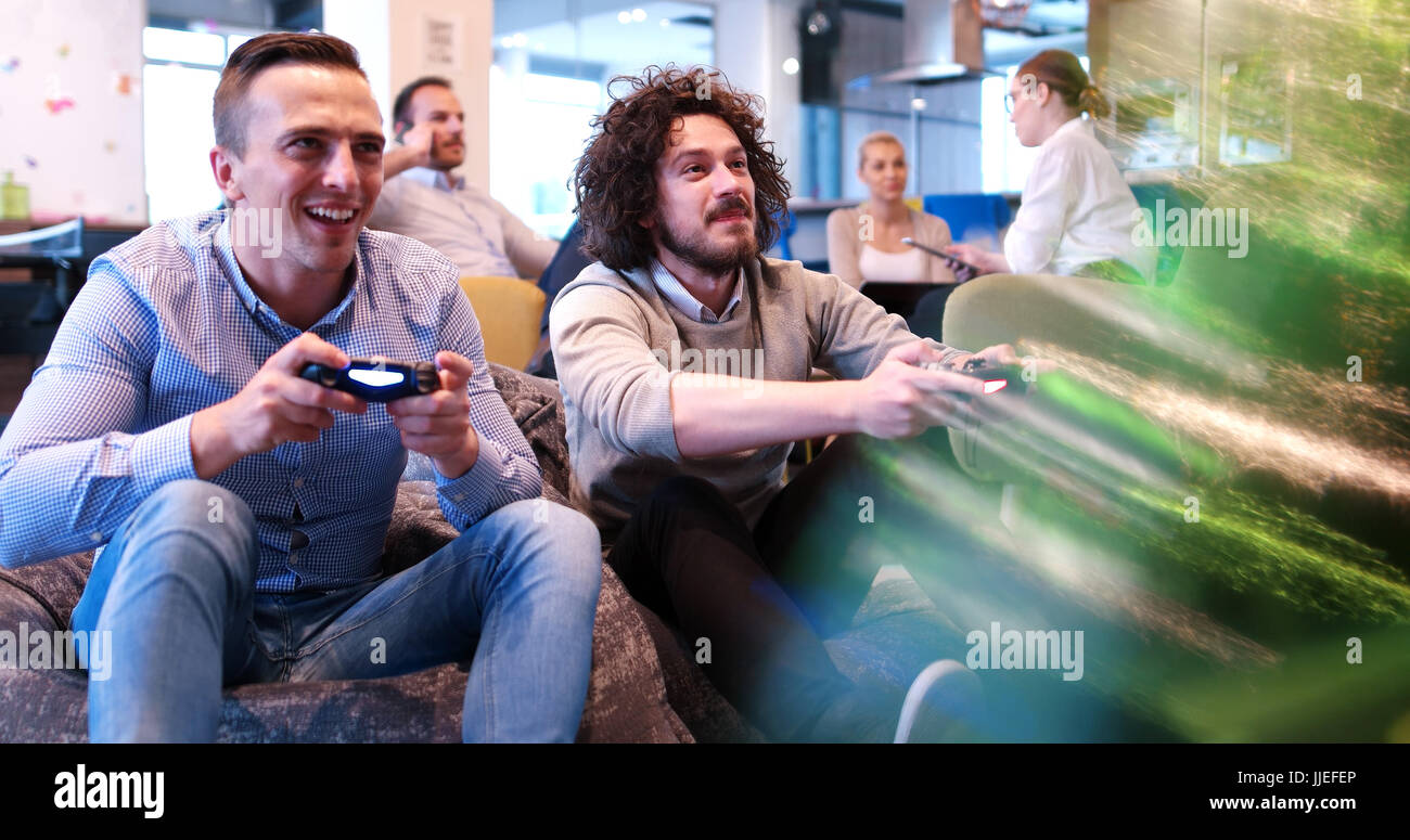 Work hard play hard. Office Workers Playing computer games Stock Photo ...