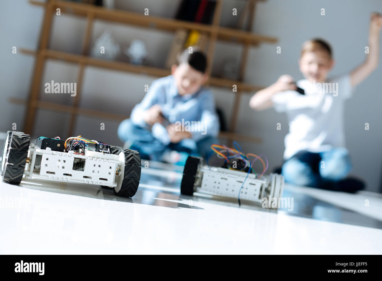 Little boys playing robotic car race Stock Photo - Alamy
