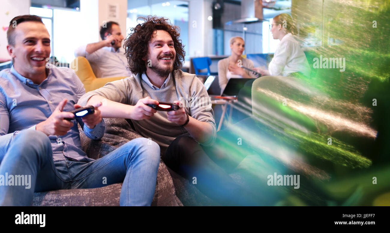 Work hard play hard. Office Workers Playing computer games Stock Photo ...