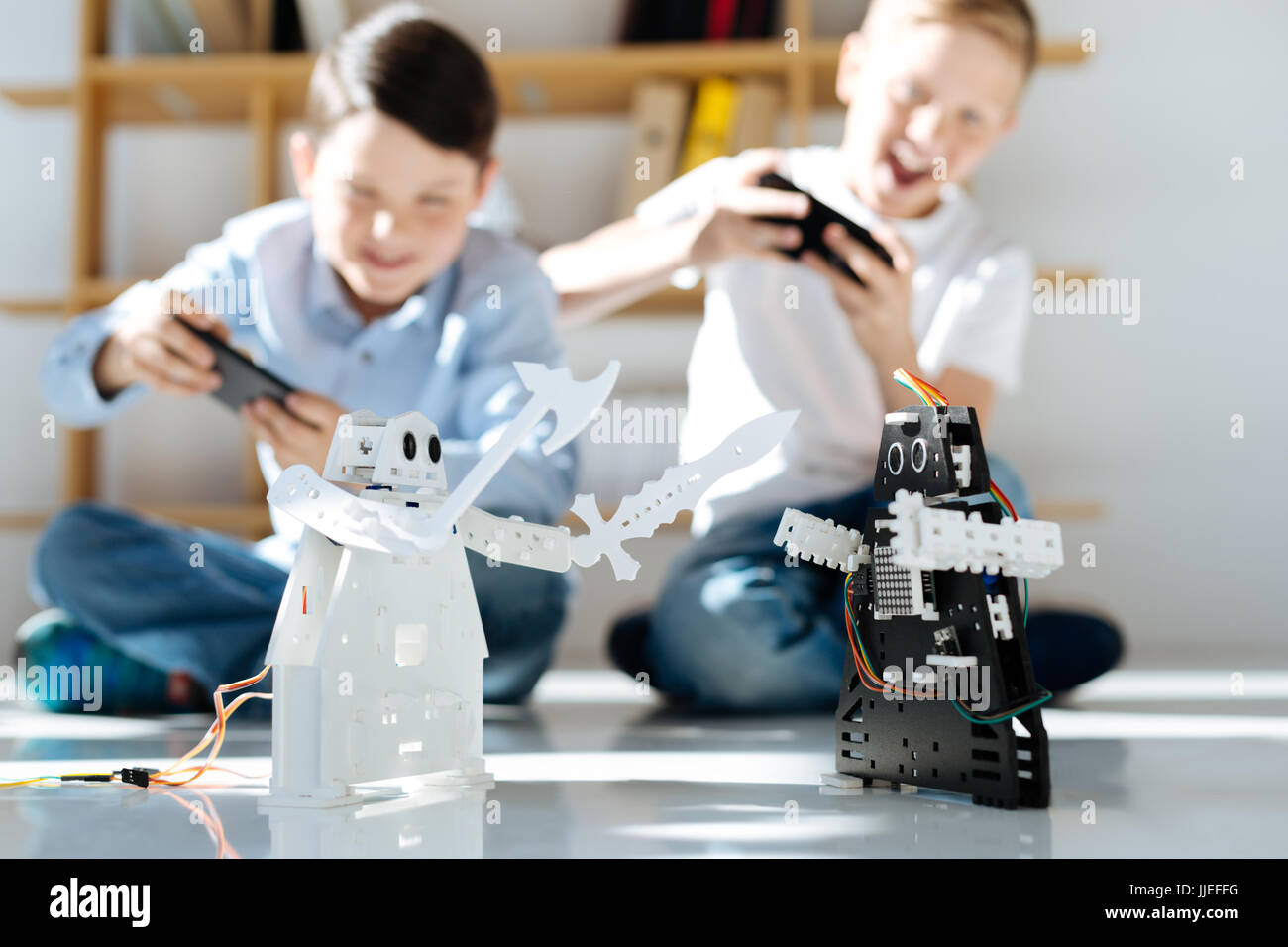 Happy boys playing with their new robot toys Stock Photo - Alamy