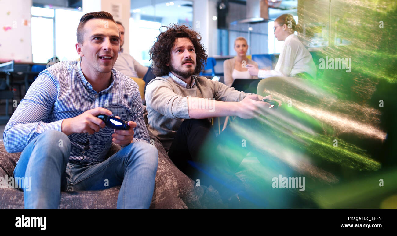 Work hard play hard. Office Workers Playing computer games Stock Photo ...
