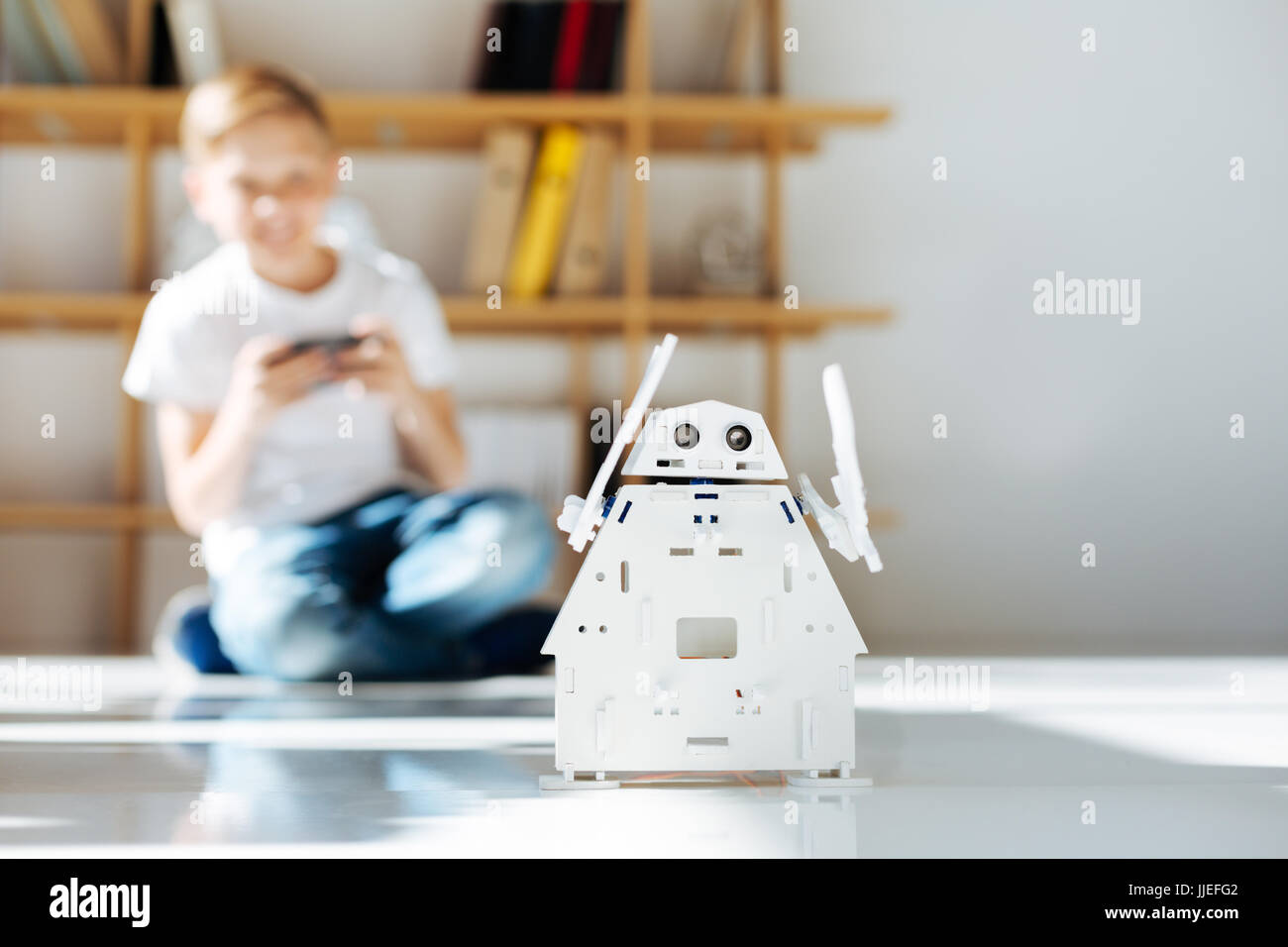 Fair-haired little boy enjoying his new robot toy Stock Photo - Alamy