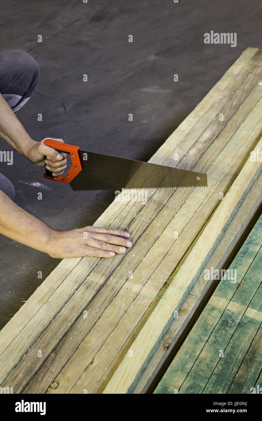 Cutting wood with hand with a saw, detail of construction worker Stock ...
