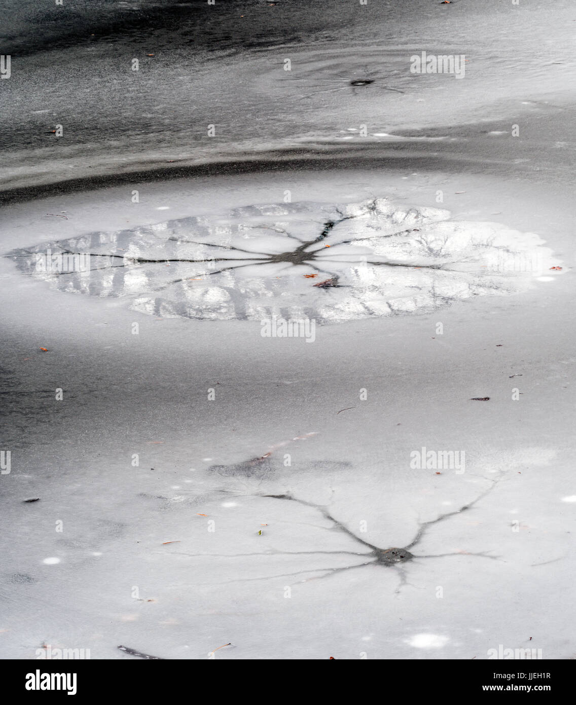 Cracking ice spots on lake in winter Central Park Stock Photo - Alamy