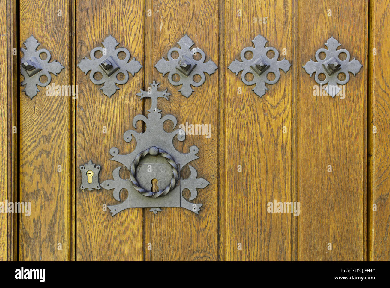 Old medieval wooden door with lock, detail of decoration and protection ...