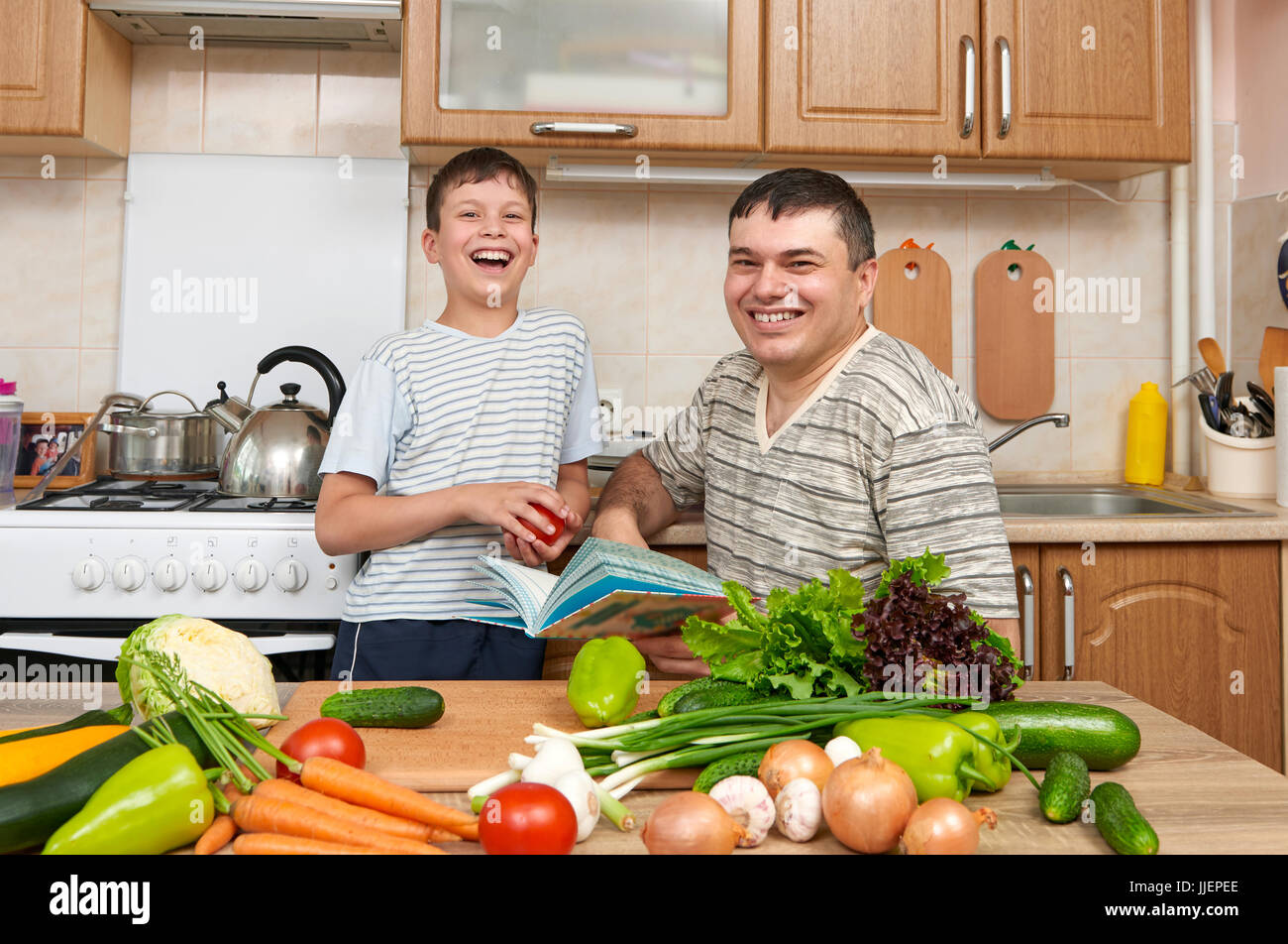Father and child reading cooking book and choice dishes. Happy family ...