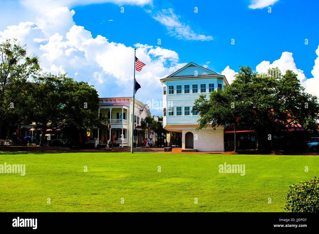 A building hiding behind a couple trees Stock Photo - Alamy