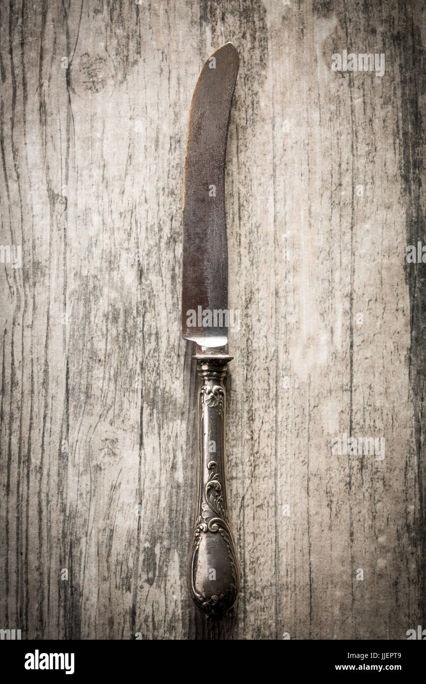 Old antique knife on dark wooden background Stock Photo - Alamy