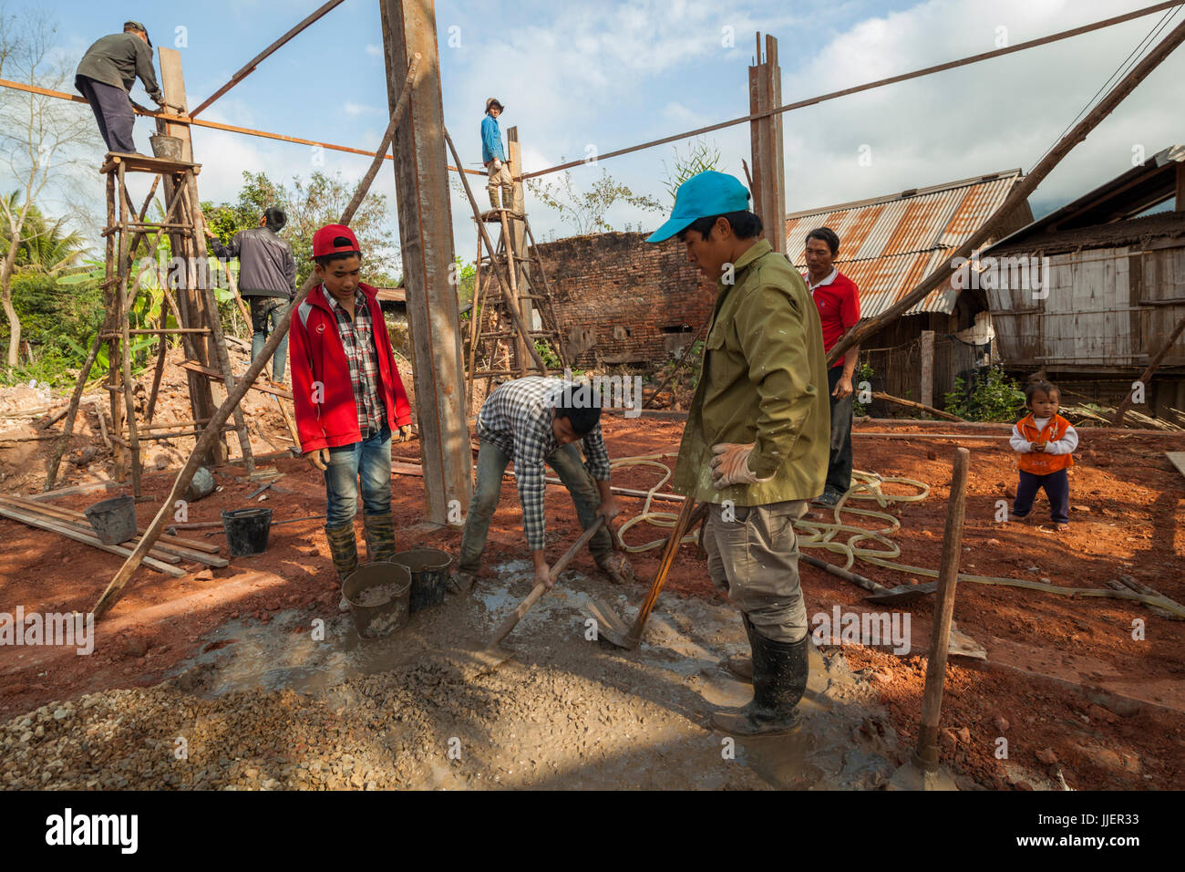 Men construct a new house with modern materials in Boun Neua, Phongsaly ...