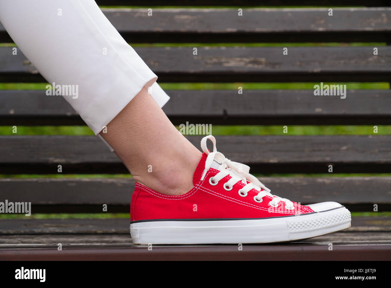Sneakers girl on the bench Stock Photo - Alamy