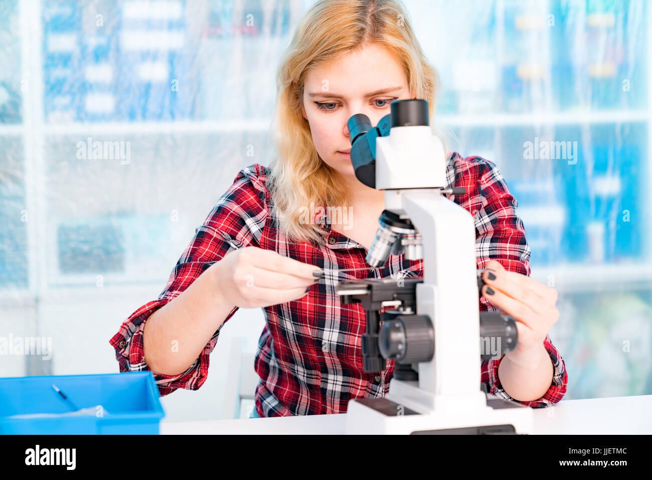 Student girl in microbiology class, learning workshop with microscope ...