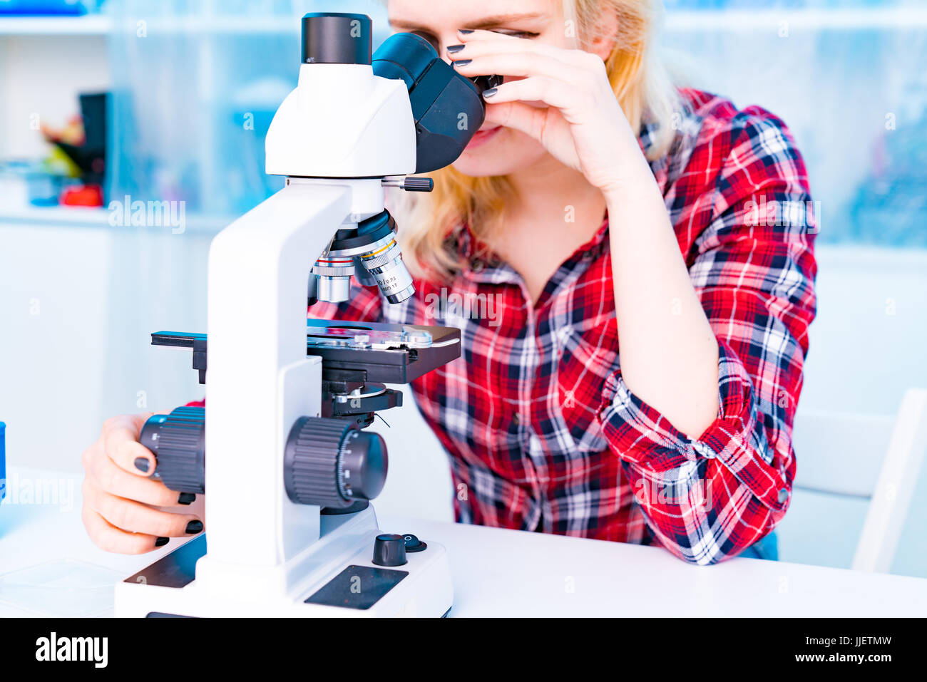 female student in biological classroom with science microscope Stock ...