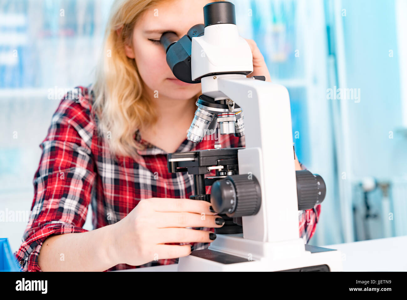 Student girl in microbiology class, learning workshop with microscope ...