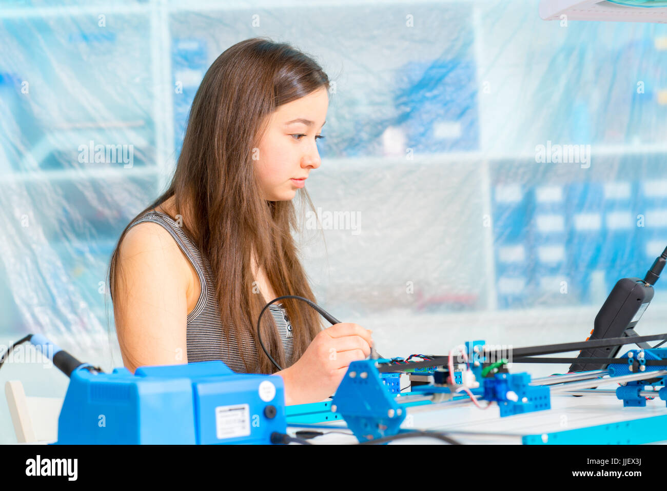 Student girl in electronics laboratory, experiment with microcontroller ...