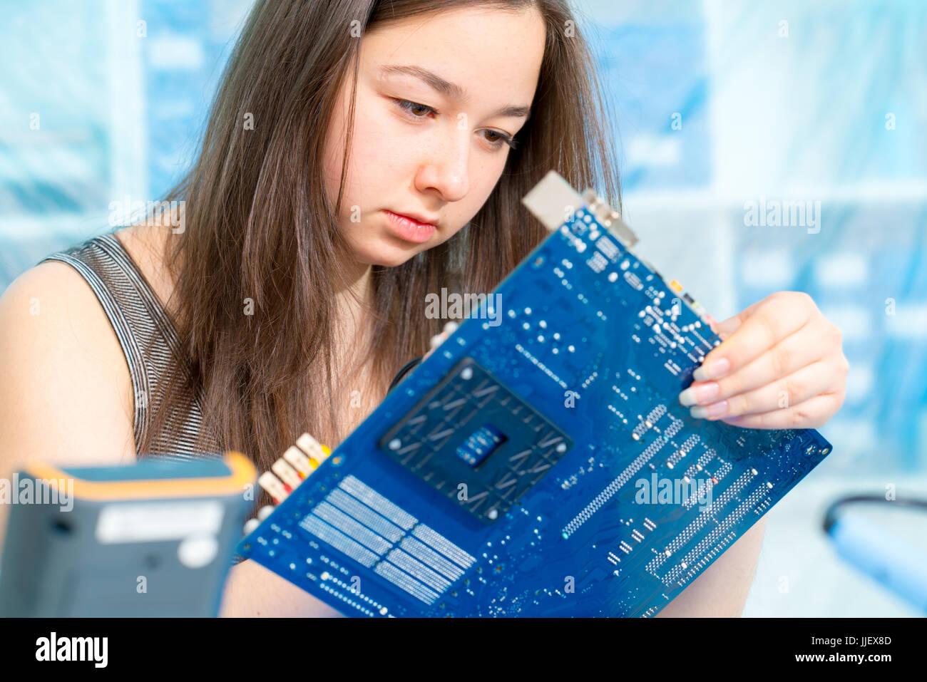 Student girl in electronics laboratory, experiment with microcontroller ...