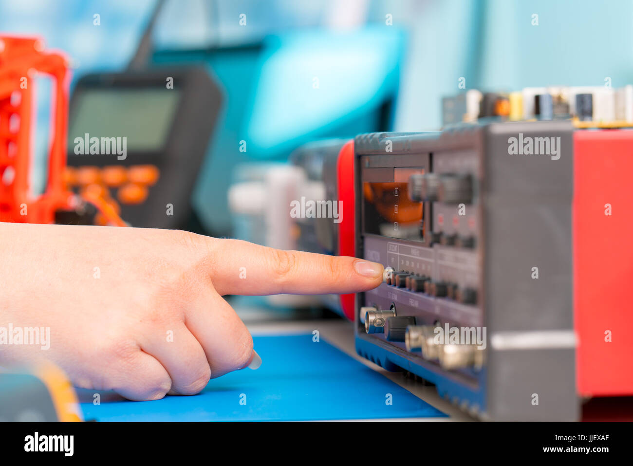 finger presses the button on the measuring instrument Stock Photo - Alamy