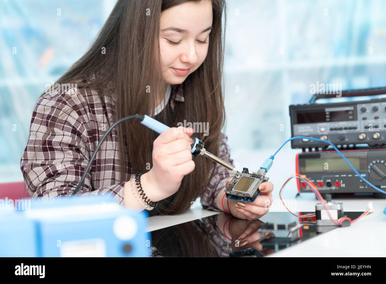 The girl adjusts the electronics system on the microprocessor Stock ...