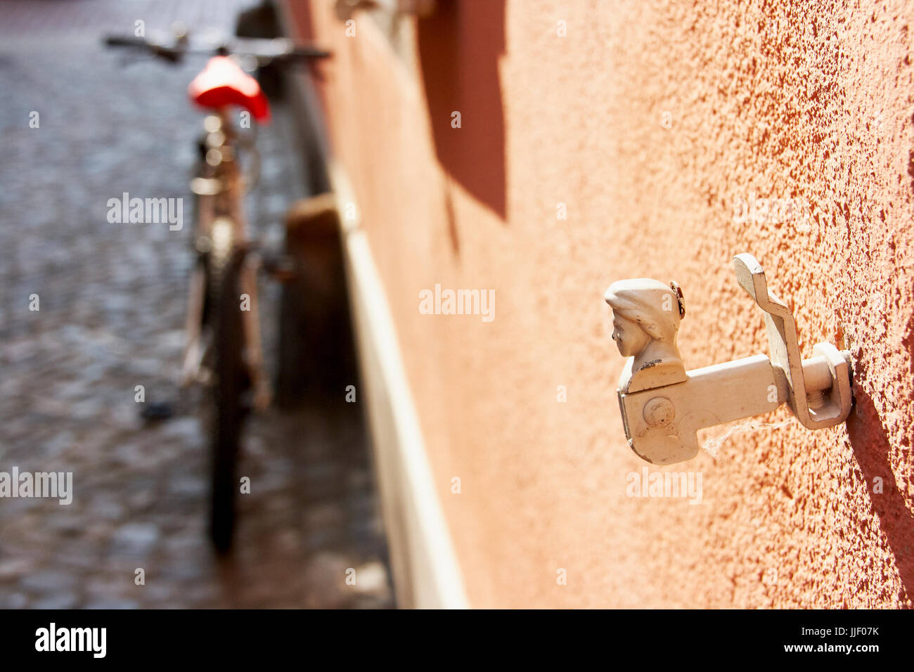 Antique window shutter holder and bike Stock Photo - Alamy