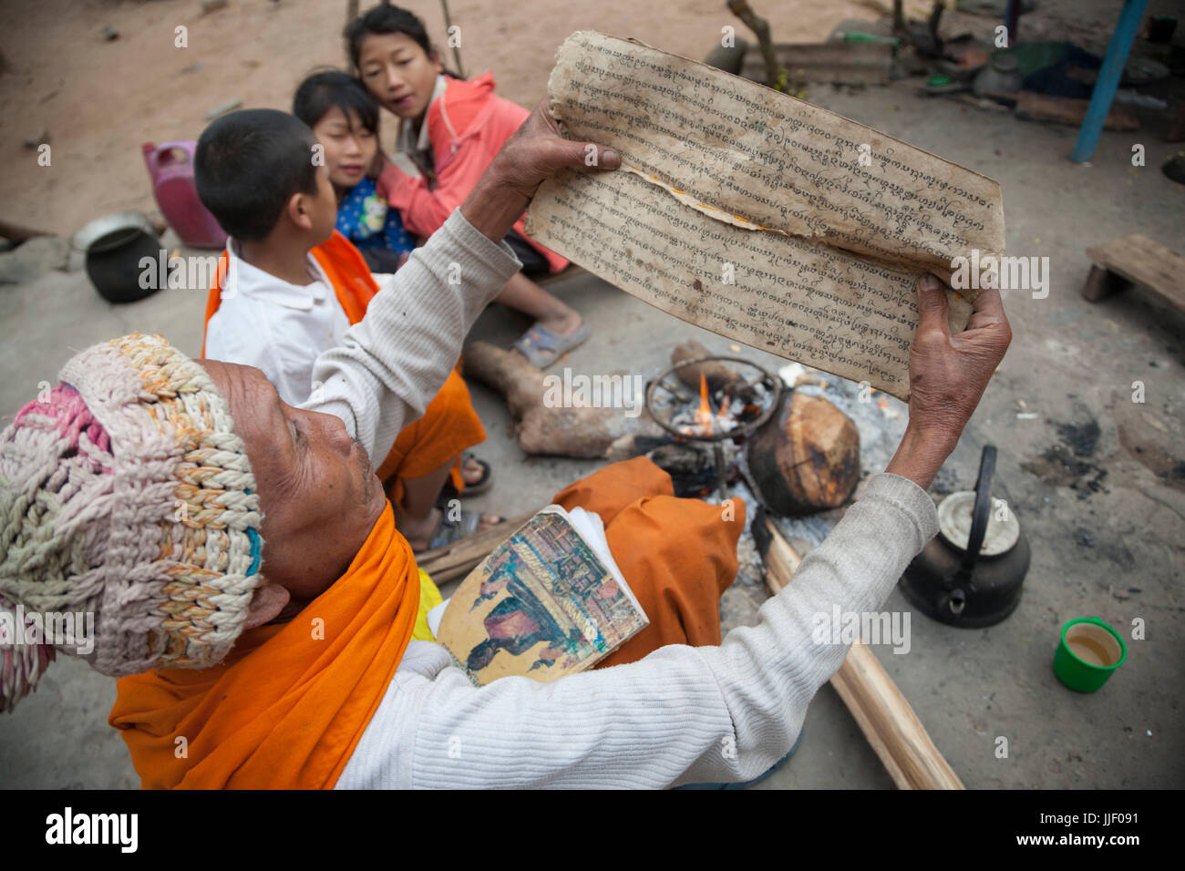 The resident monk holds up Sanskrit scripture at the Buddhist monastery ...