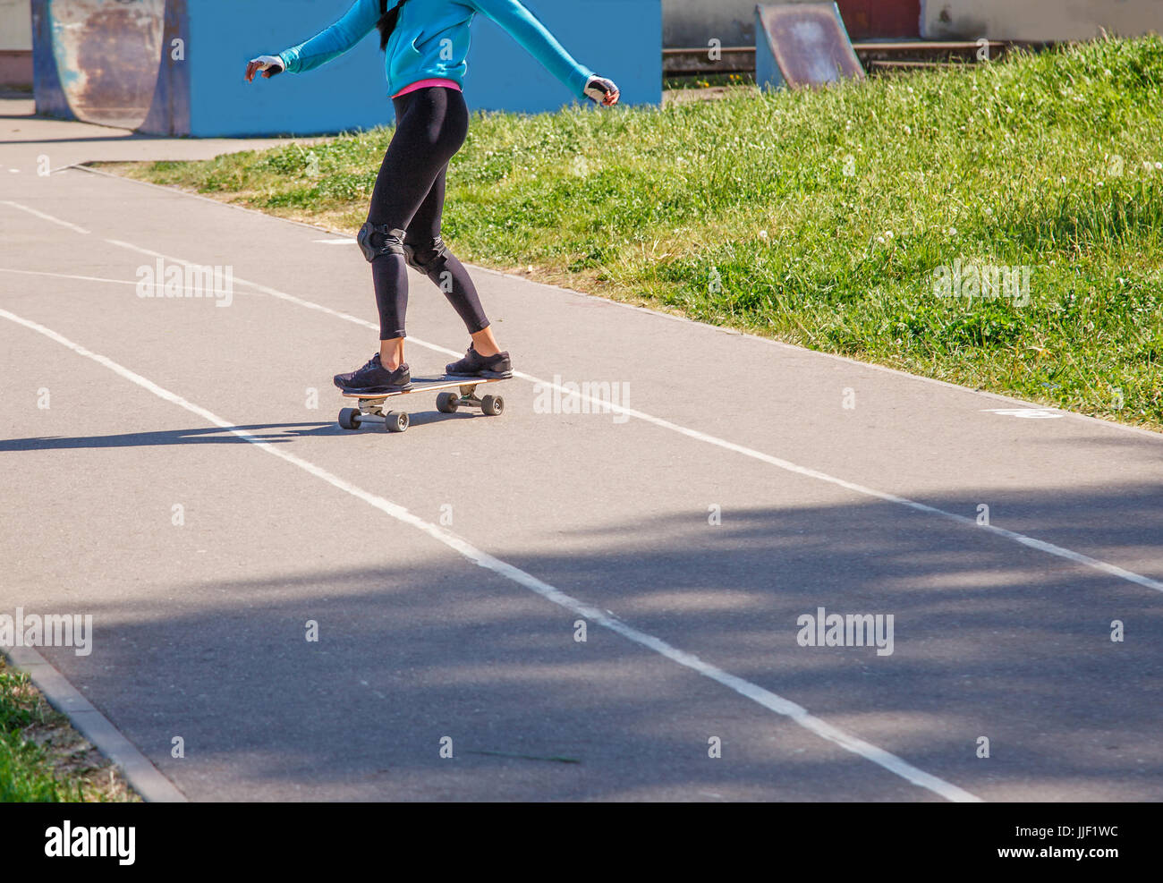Woman skateboarding in the park Stock Photo - Alamy