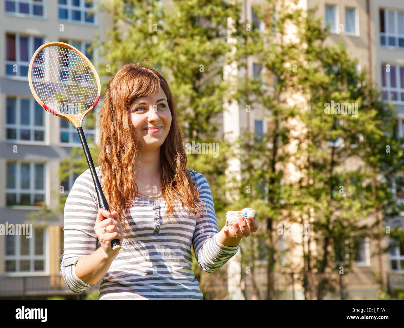 Smiling woman playing badminton Stock Photo - Alamy