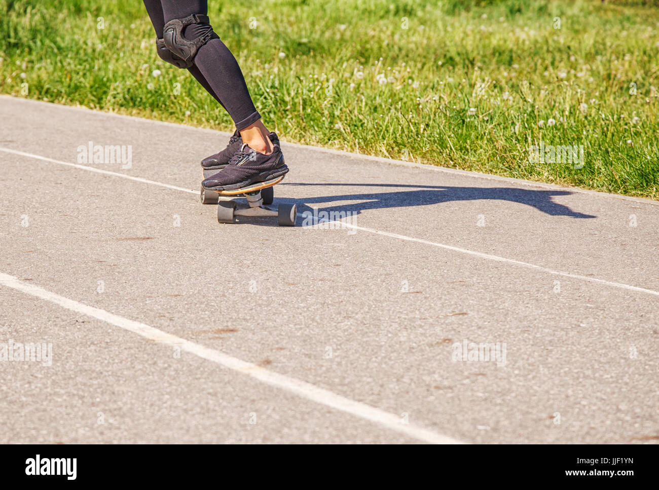 Woman skateboarding in the park Stock Photo - Alamy