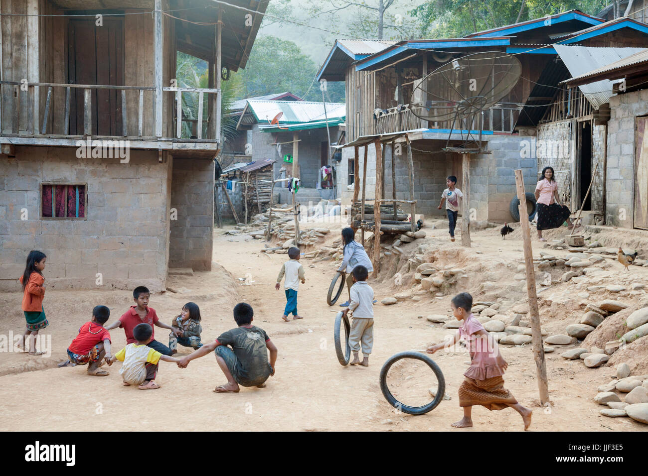 Children stand in a circle holding hands or play with bicycle ties in a ...