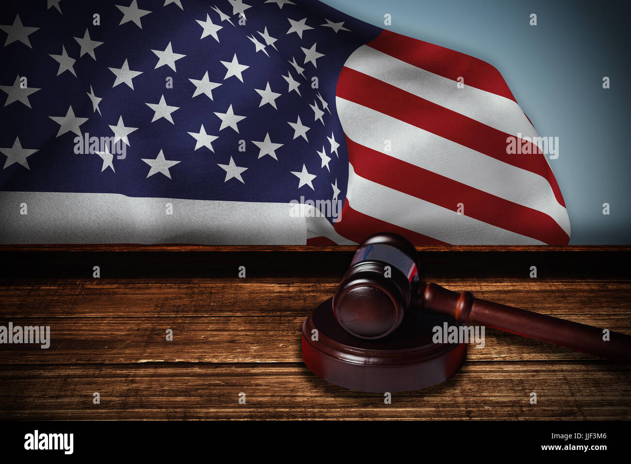 Hammer and gavel against grey vignette Stock Photo - Alamy