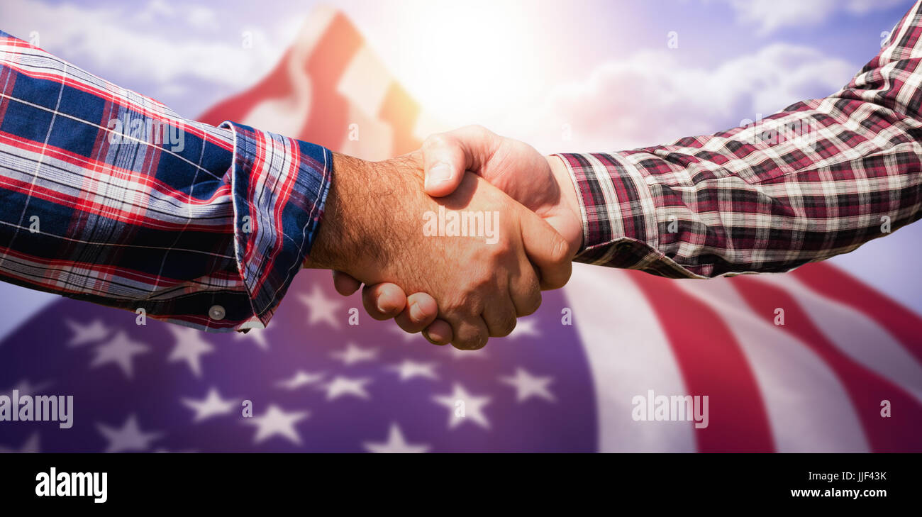 Male friends shaking hands against composite image of focus on usa flag ...