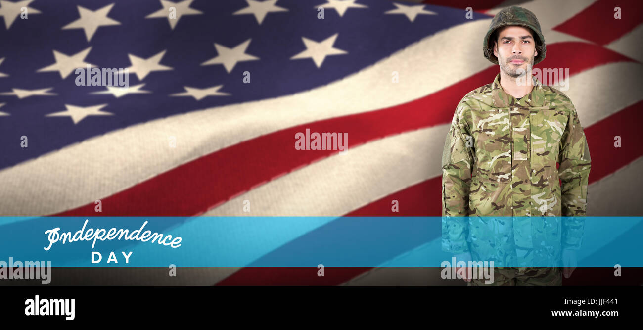 Portrait of confident military soldier standing against waving flag of ...