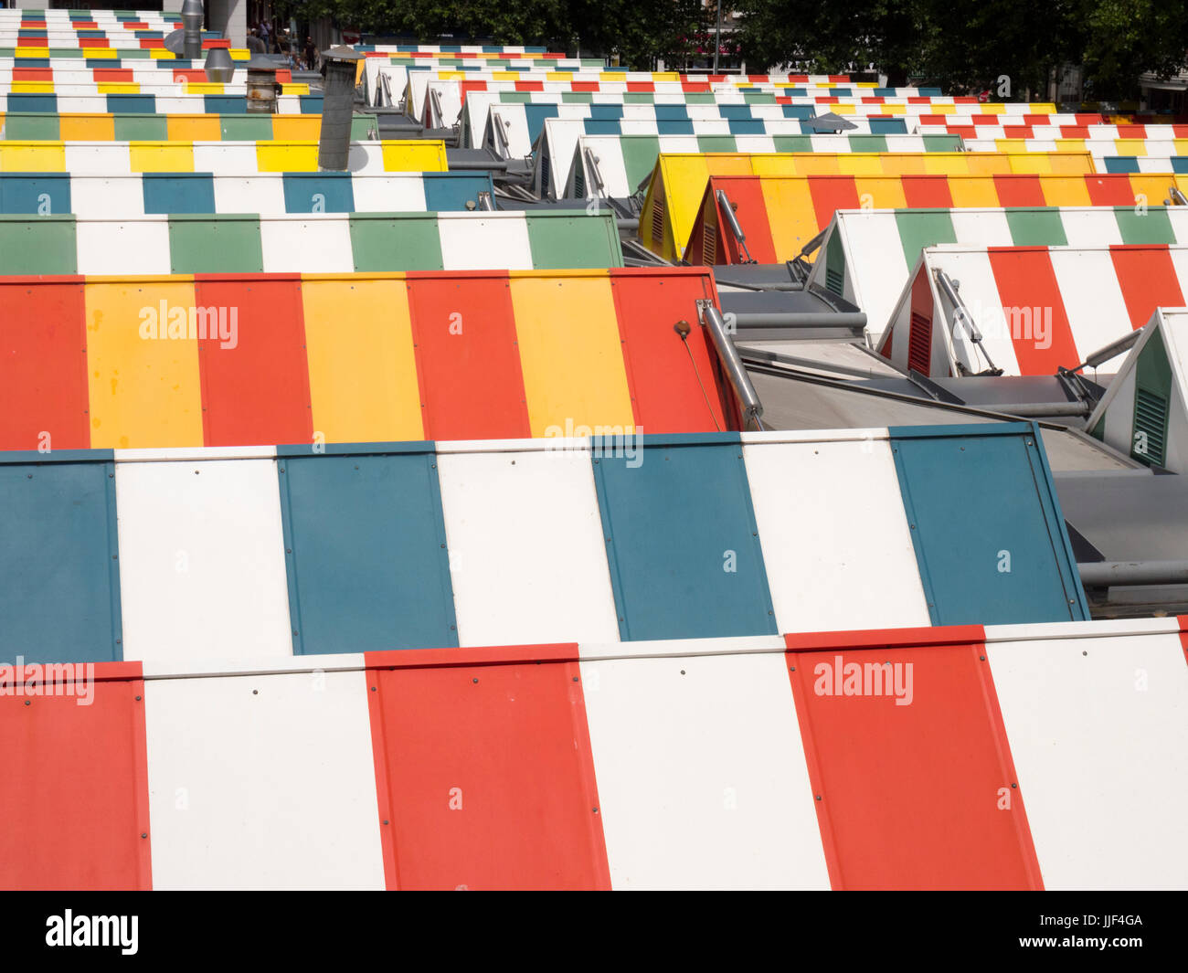 The colourful striped roofs of the market stall in the covered market ...